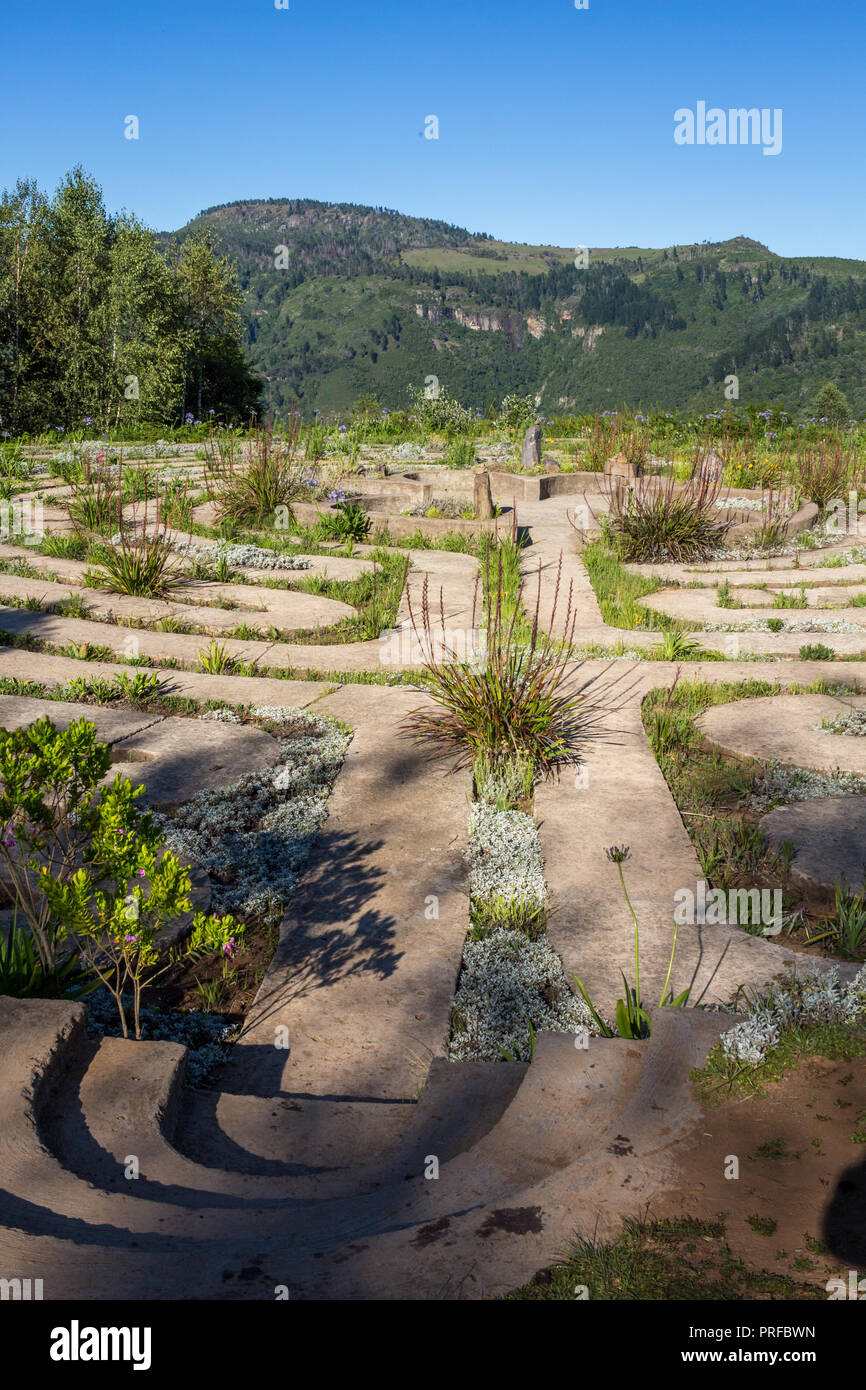 Concrete path of labyrinth with shadows on the steps in the morning ...