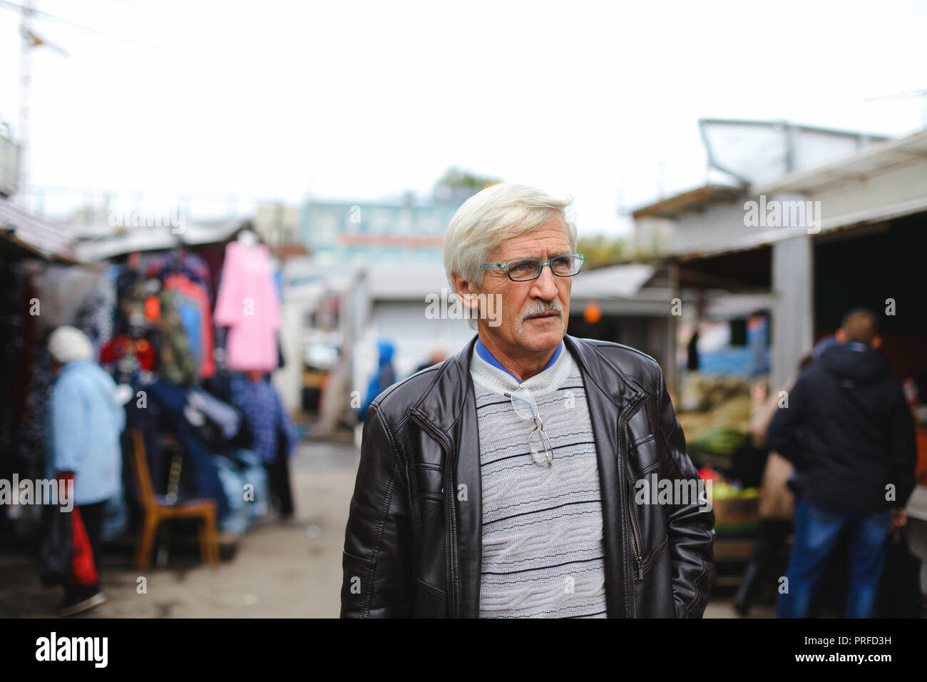 portrait of a man 60 years old. the man wears glasses he has poor ...