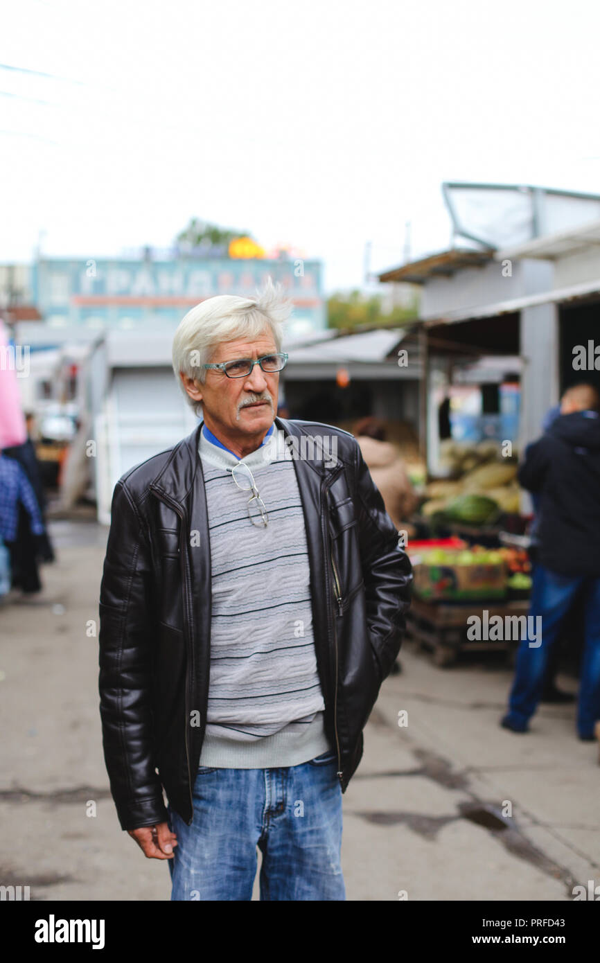 portrait of a man 60 years old. the man wears glasses he has poor ...