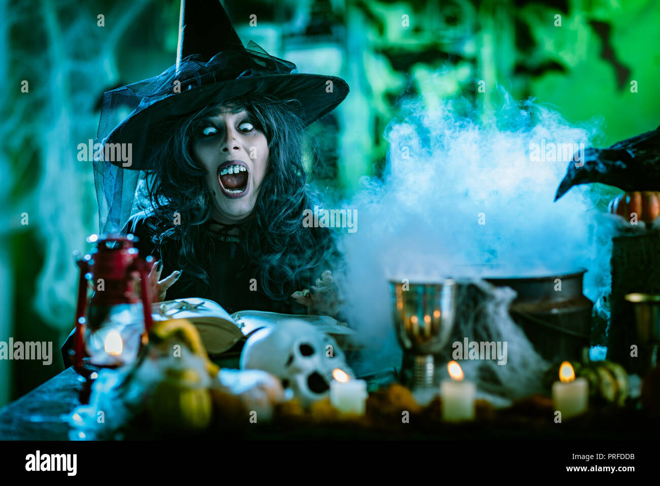 Witch with awfully face in creepy smoky green surroundings full of ...