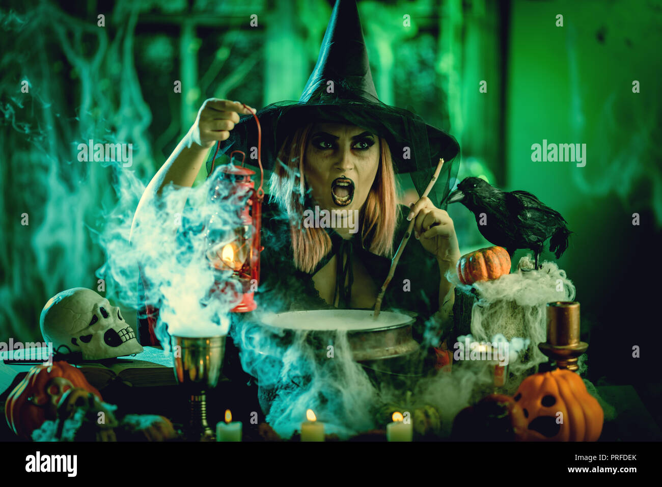 Witch with smiling face in creepy surroundings cooks poison soup in ...