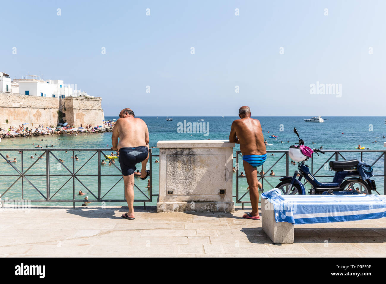 Two old men in front of the town beach in Monopoli, Puglia, Italy Stock ...