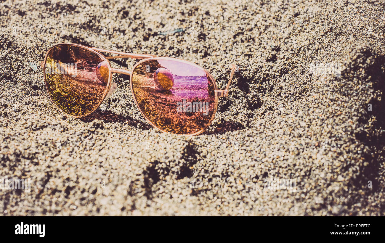 Sunglasses at the beach with beach ball reflection Stock Photo - Alamy