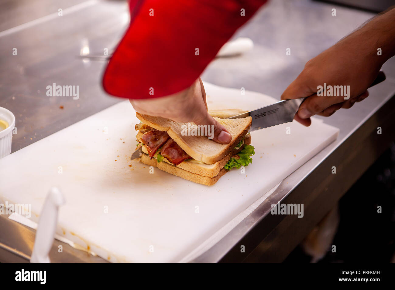 Chef making sandwich in rustic style with bacon and fresh vegetables ...