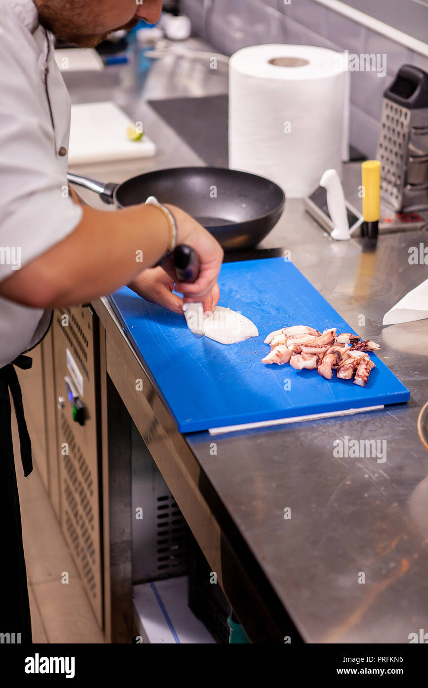 Male cook slicing seafood in restaurant kitchen.Delicious food Stock ...