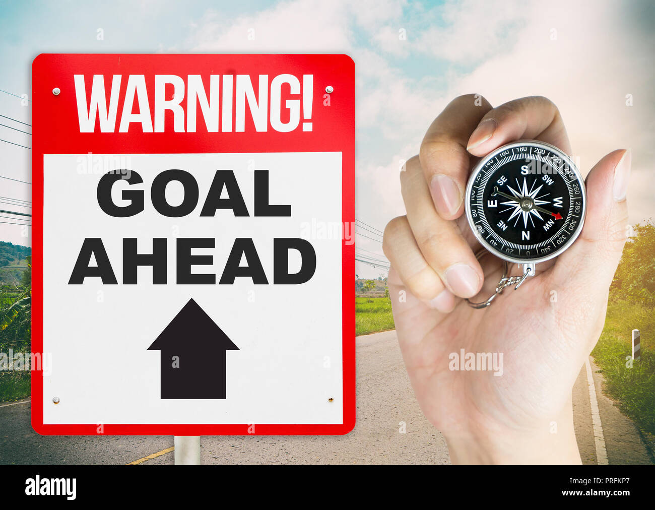 Warning sign goal ahead with hand holding compass for direction Stock ...