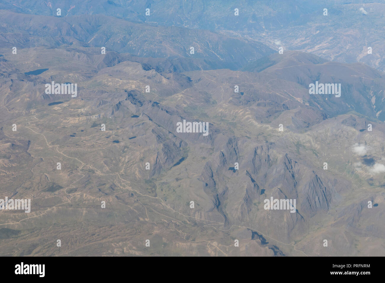 Aerial view of dry desert and the Andes Mountains somewhere over South ...
