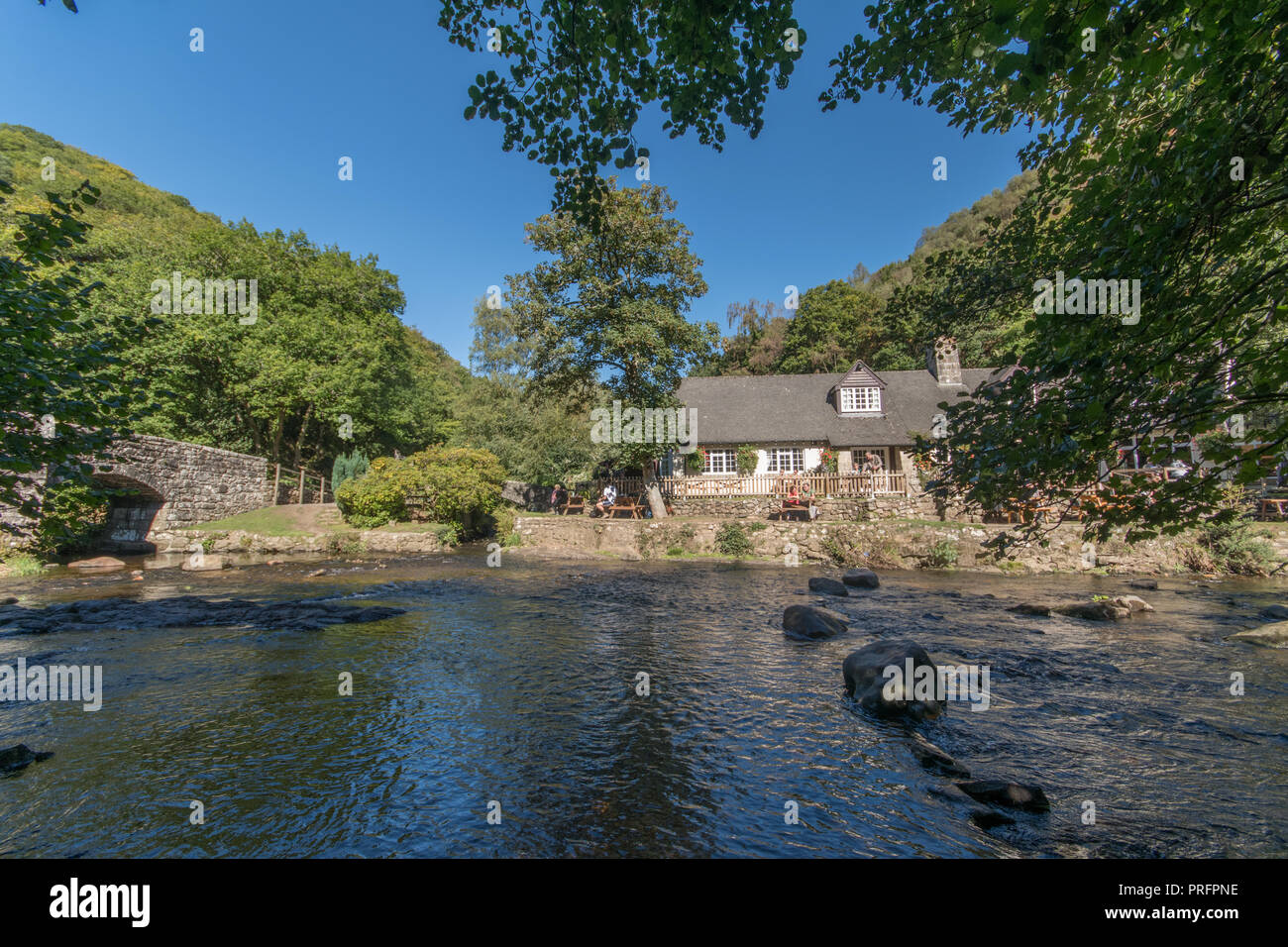 Fingle Bridge Inn next to the river Teign in Dartmoor with people ...