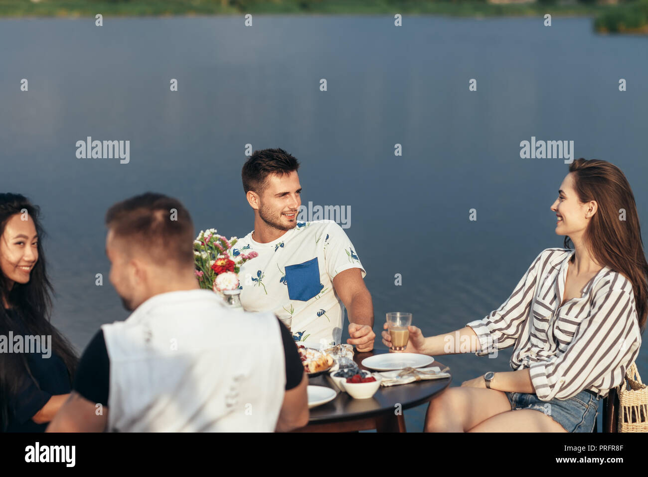Friends having fun during the dinner in outdoor restaurant. Food, fun ...