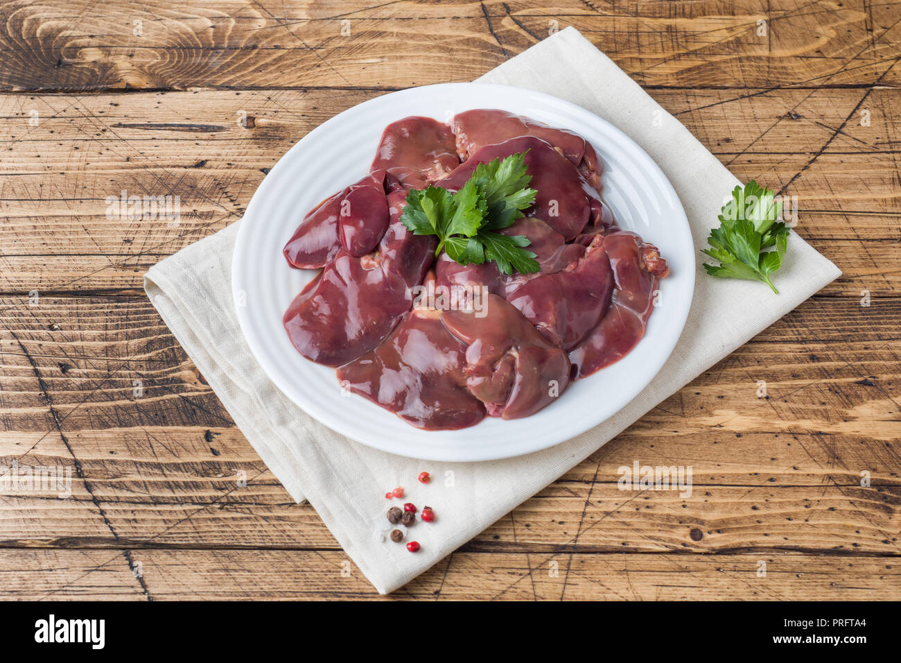 Fresh raw chicken liver on a plate. Wooden rustic background Stock ...
