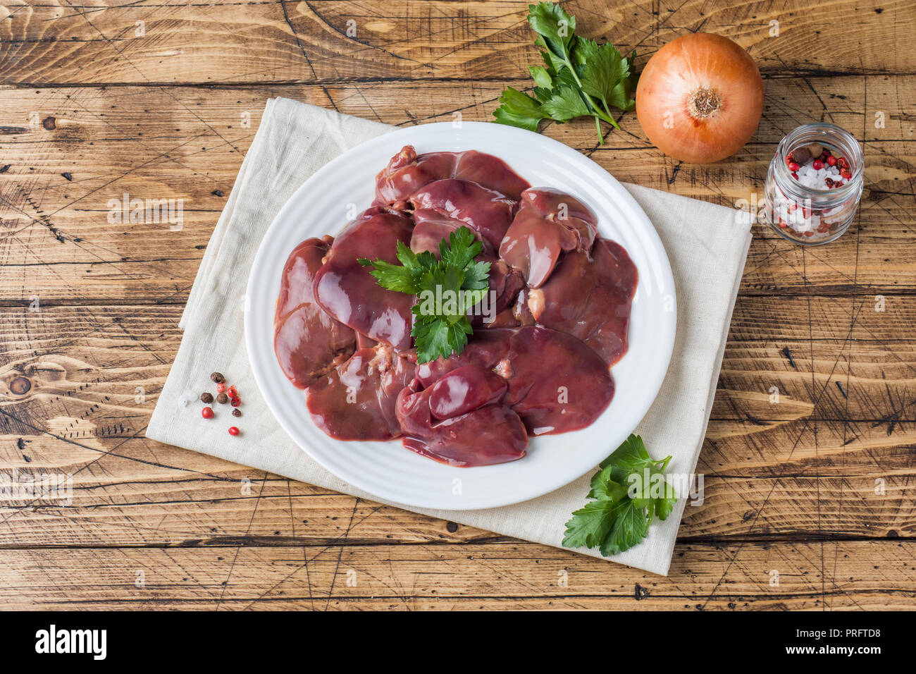 Fresh raw chicken liver on a plate. Wooden rustic background Stock ...