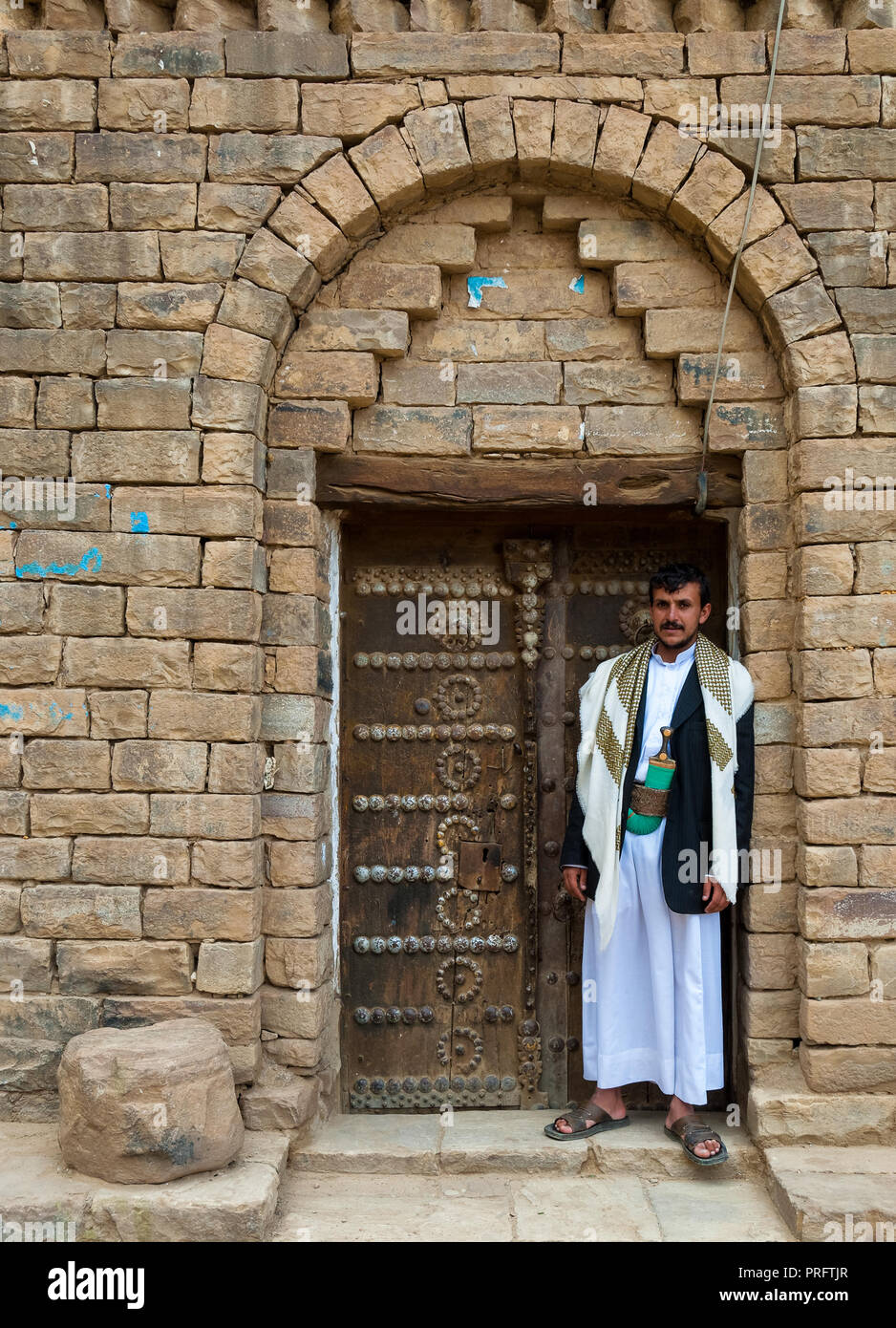 A man in traditional clothes and wearing his janbiya poses at the ...