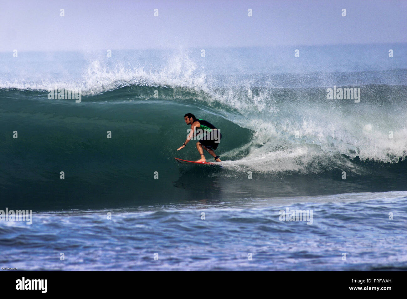 Surfer riding a surfing wave in Cimaja, West Java, Indonesia Stock ...