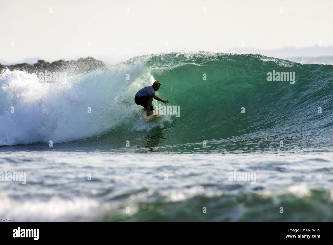 Surfing over coral reef in Pangandaran, Java, Indonesia Stock Photo - Alamy