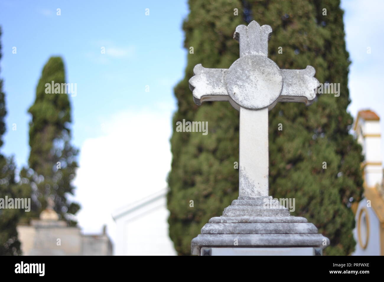 White marble cross on the tomb of a cemetery Stock Photo - Alamy