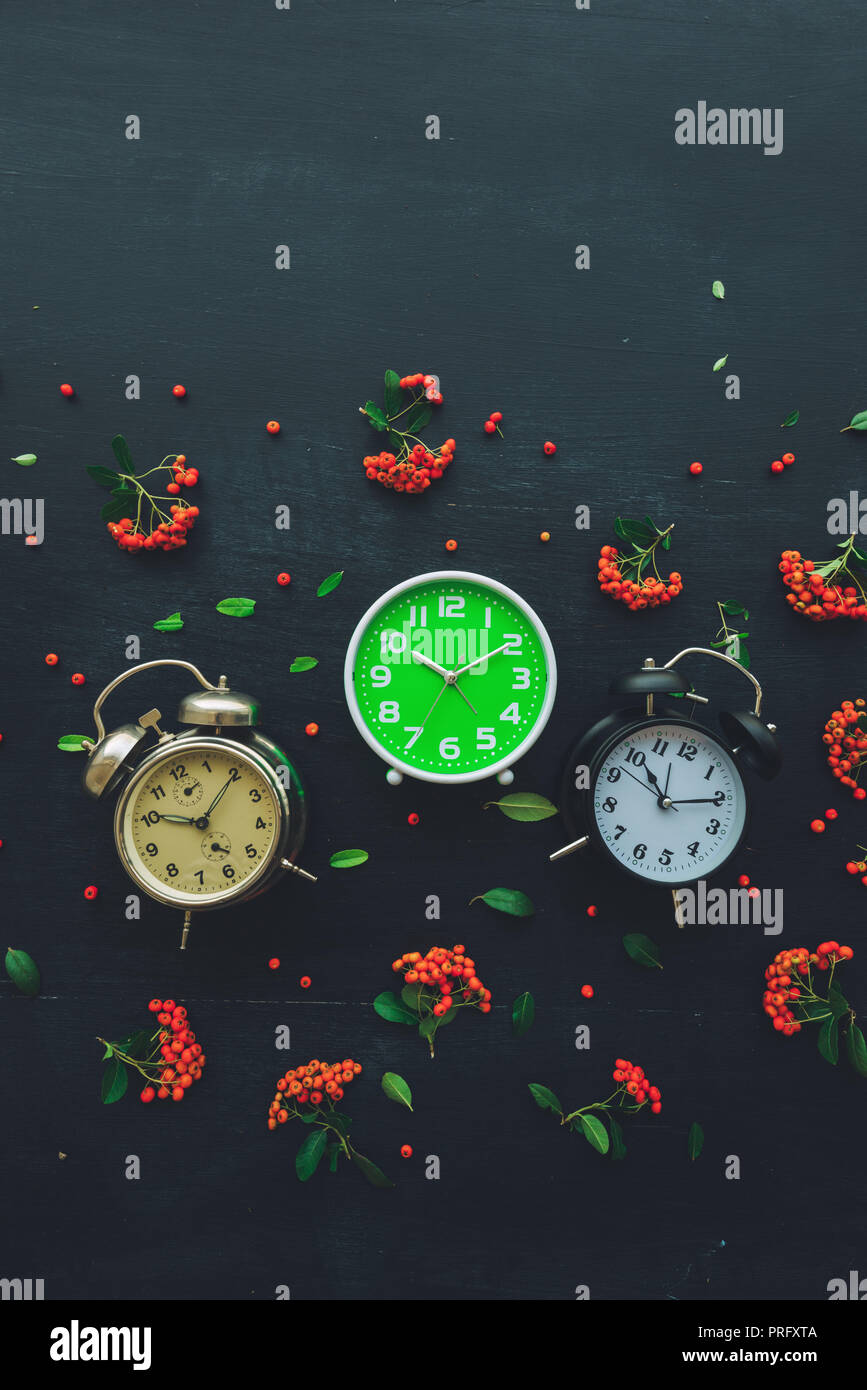 Ten past ten on three different alarm clock, flat lay top view minimal ...