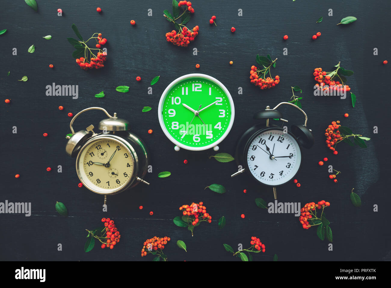 Ten past ten on three different alarm clock, flat lay top view minimal ...
