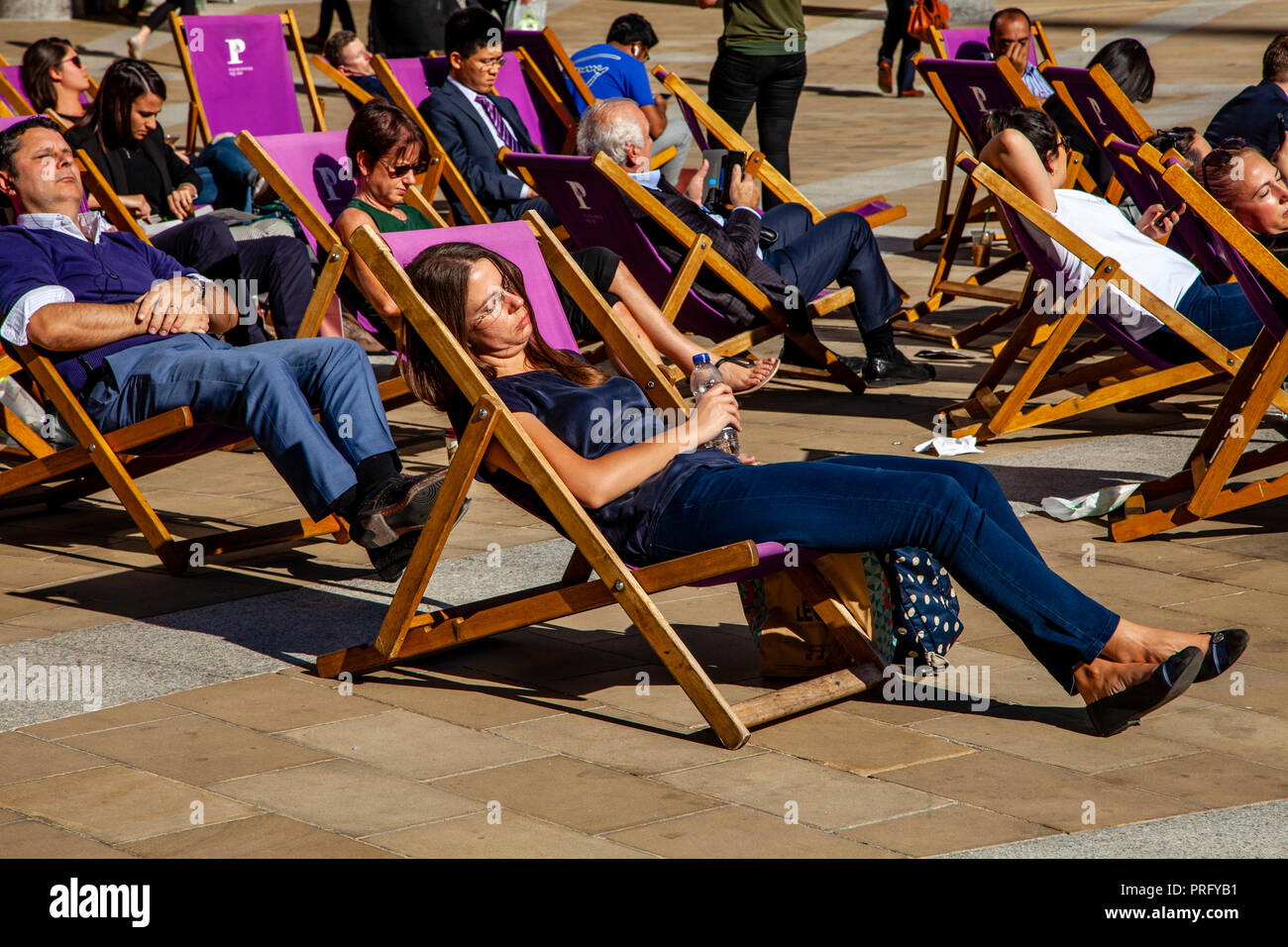 People Sitting In Deck Chairs High Resolution Stock Photography and ...