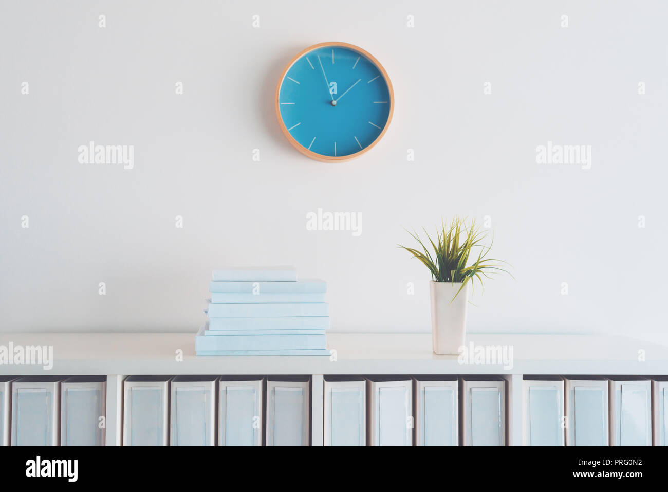 Modern bright business office interior detail depicting wall clock and ...