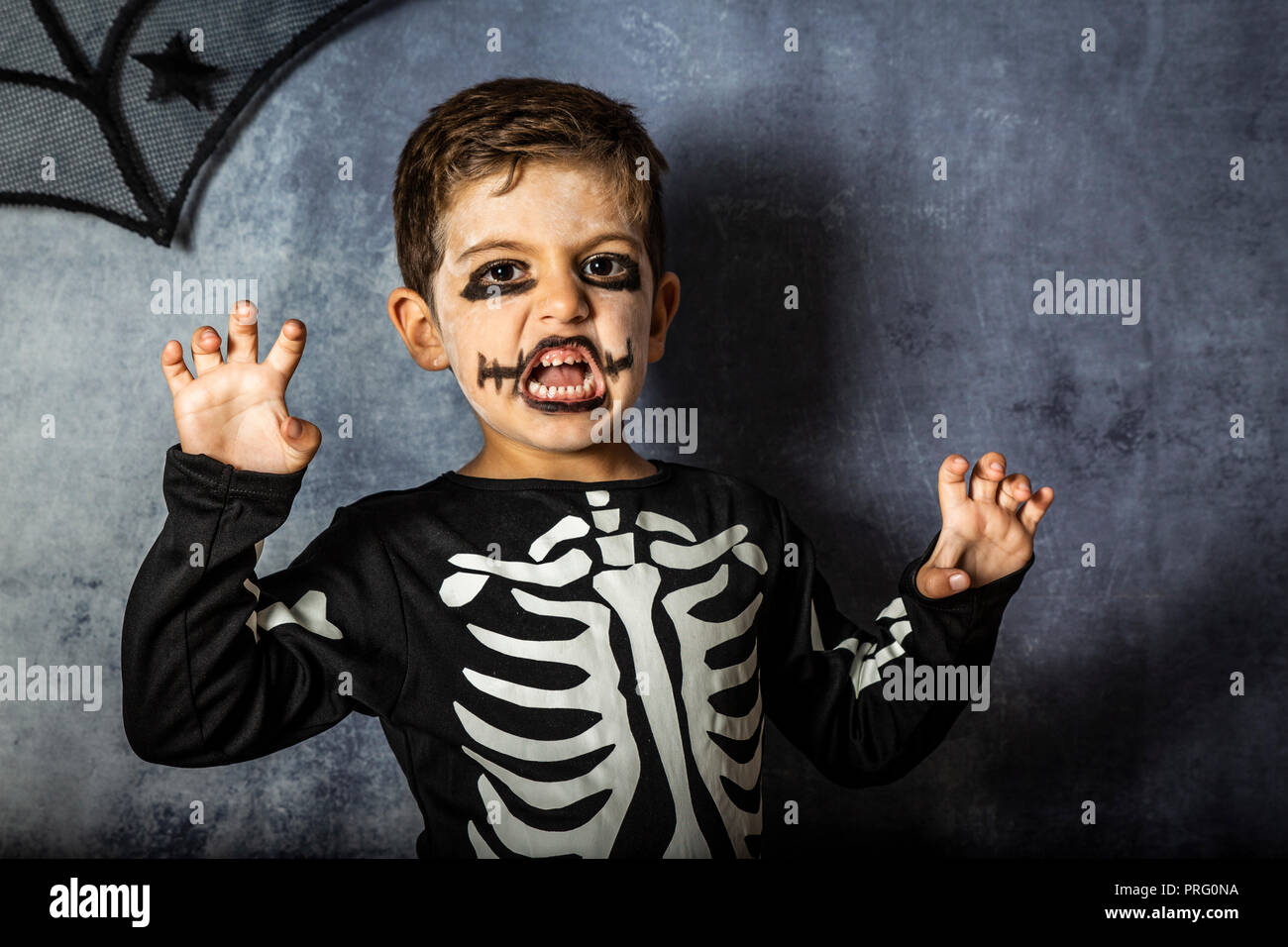 Little kid in a skeleton costume on Halloween Carnival Stock Photo - Alamy