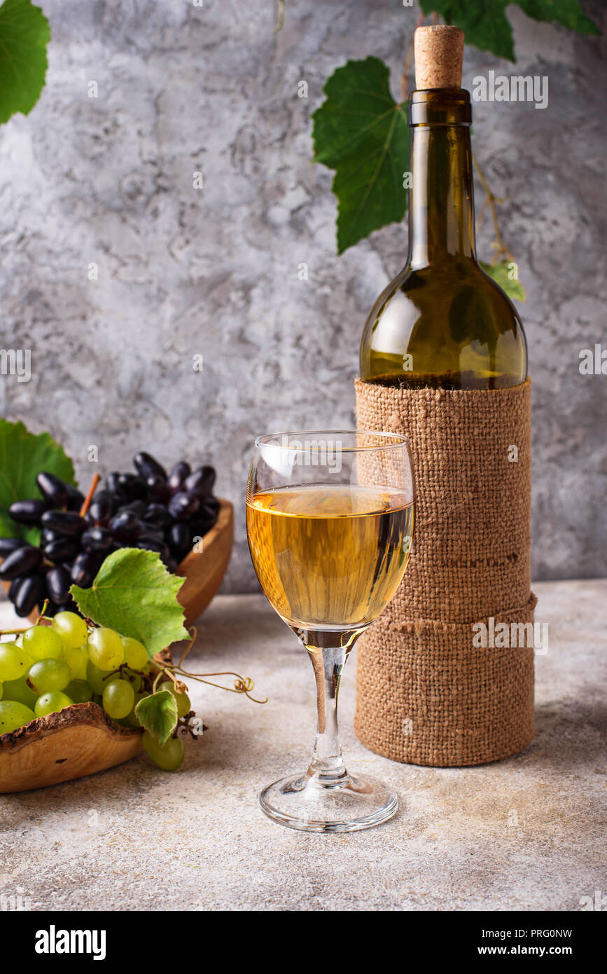 Grape, bottle and glass of white wine Stock Photo - Alamy