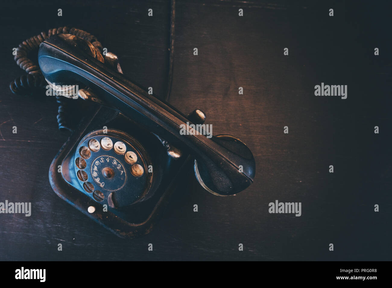Black vintage landline telephone, old and weathered. Broken ...