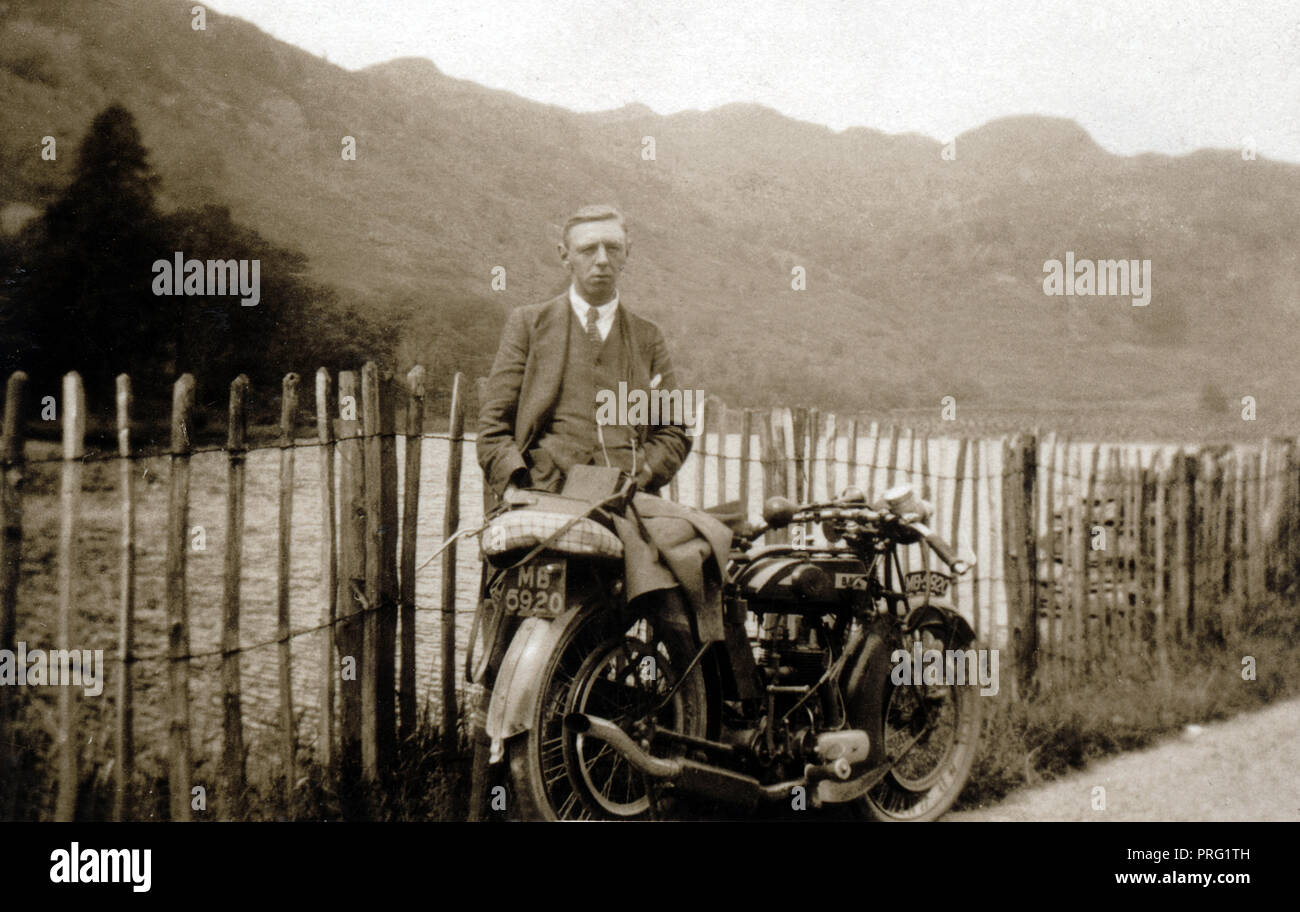 Gentlemen poses with his 1922 BSA 500cc motorcycle in the countryside ...