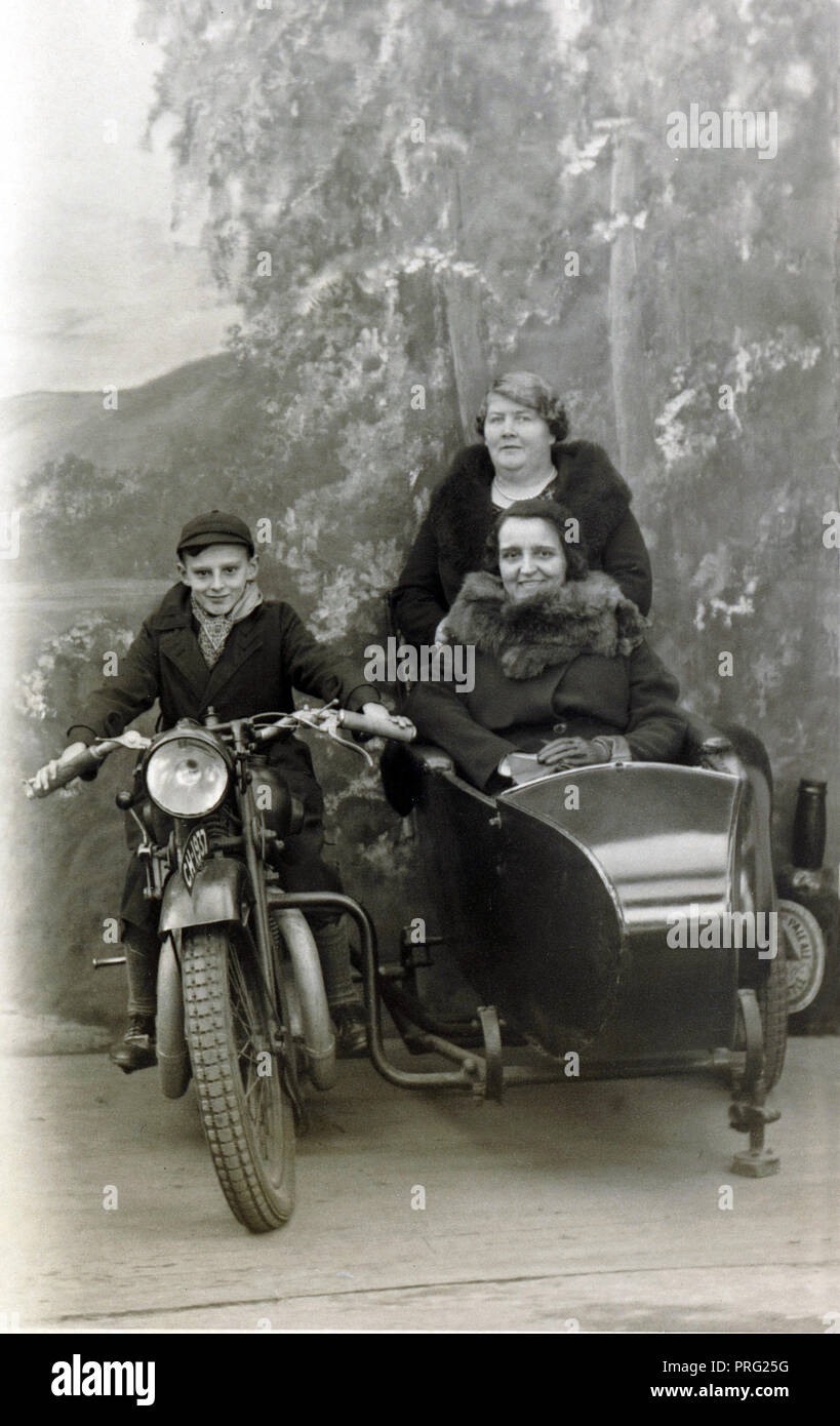 Boy and two ladies pose for a studio photograph on a 1929 Coventry ...