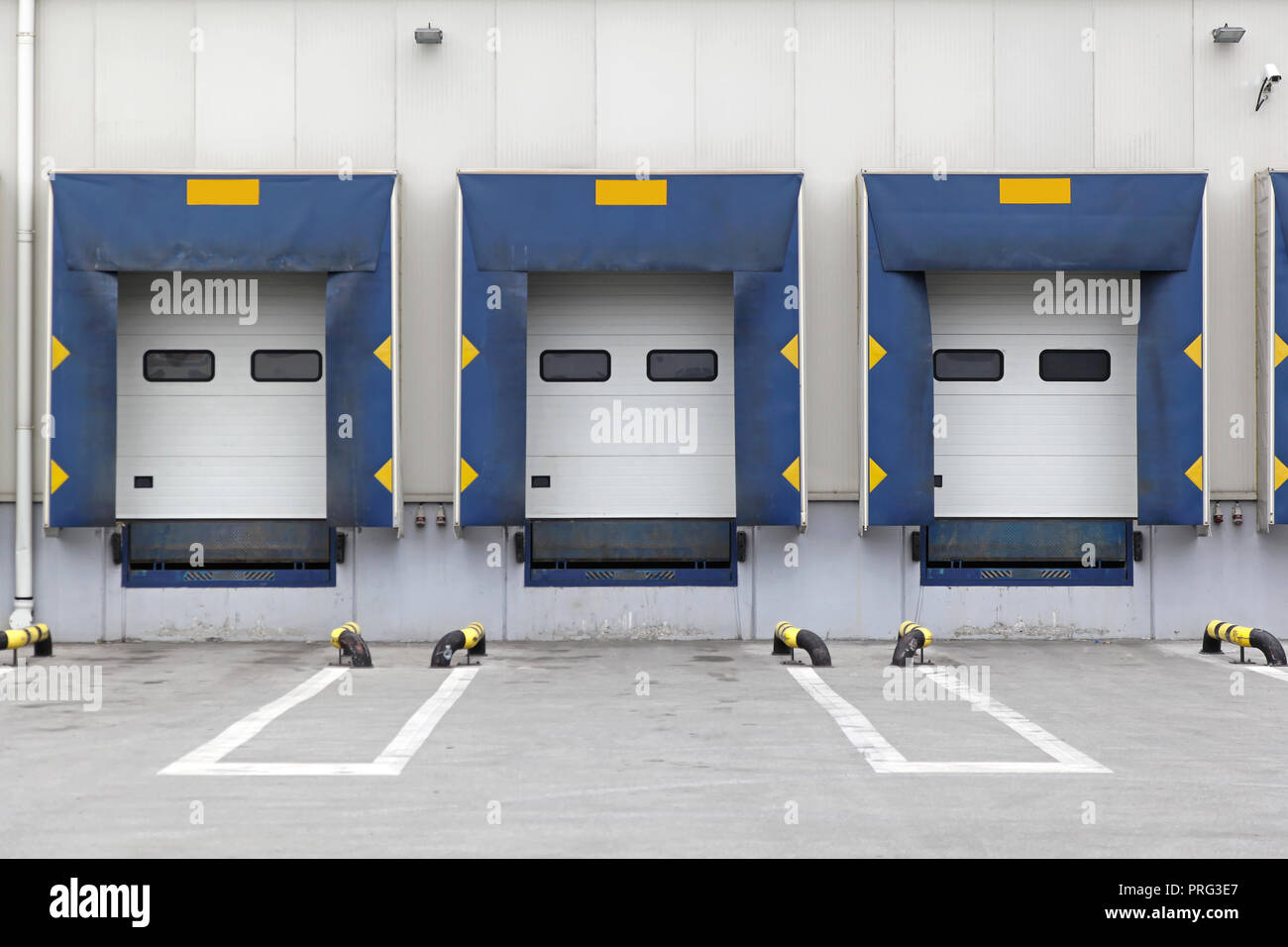 Three loading ramp doors at distribution warehouse Stock Photo - Alamy