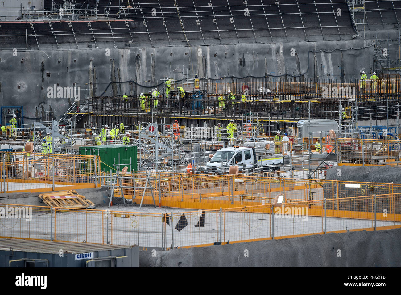 Construction workers fit reinforced concrete steel bars close to where ...