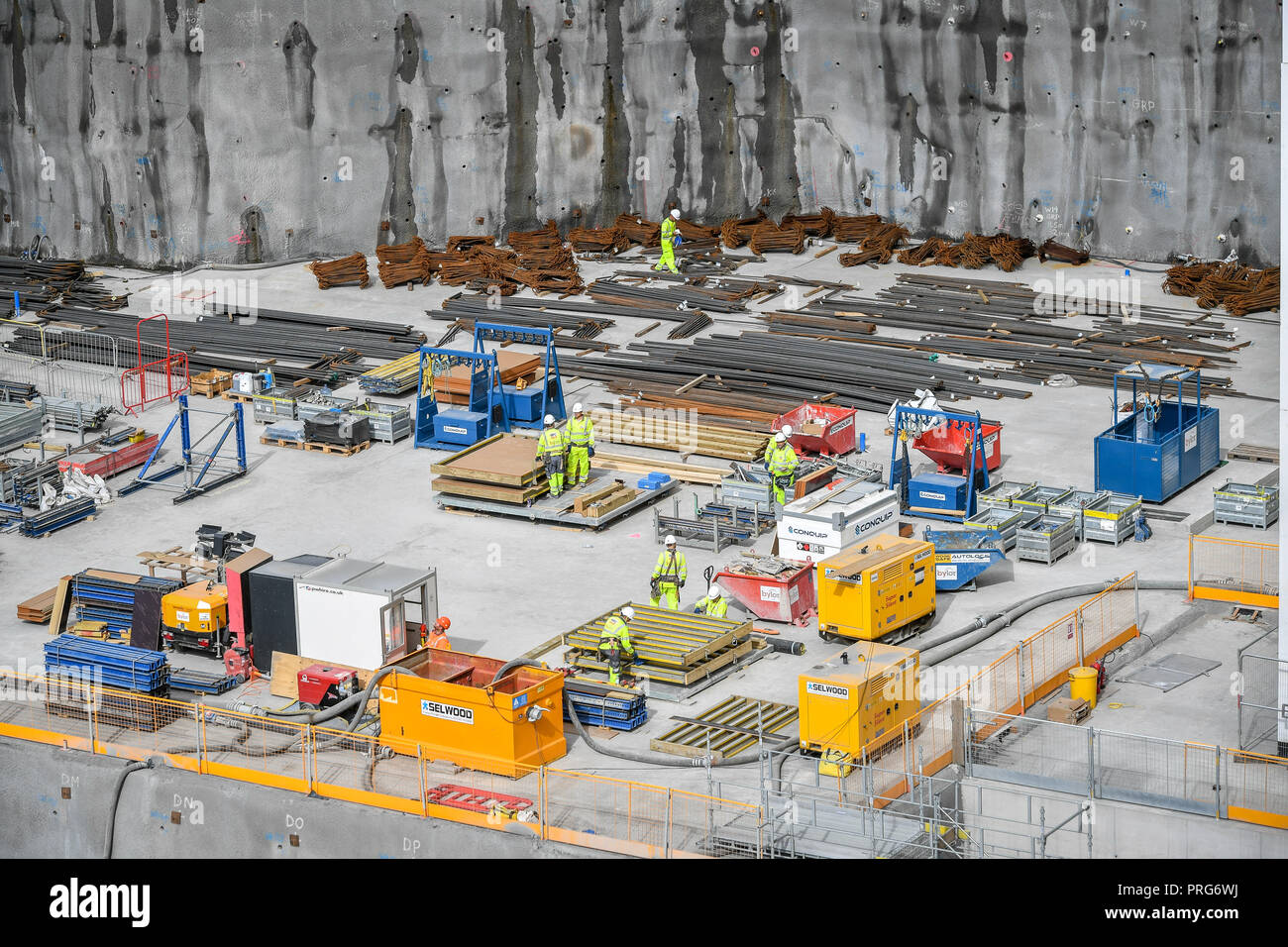 Workers surrounded by construction materials at the EDF Energy Hinkley ...