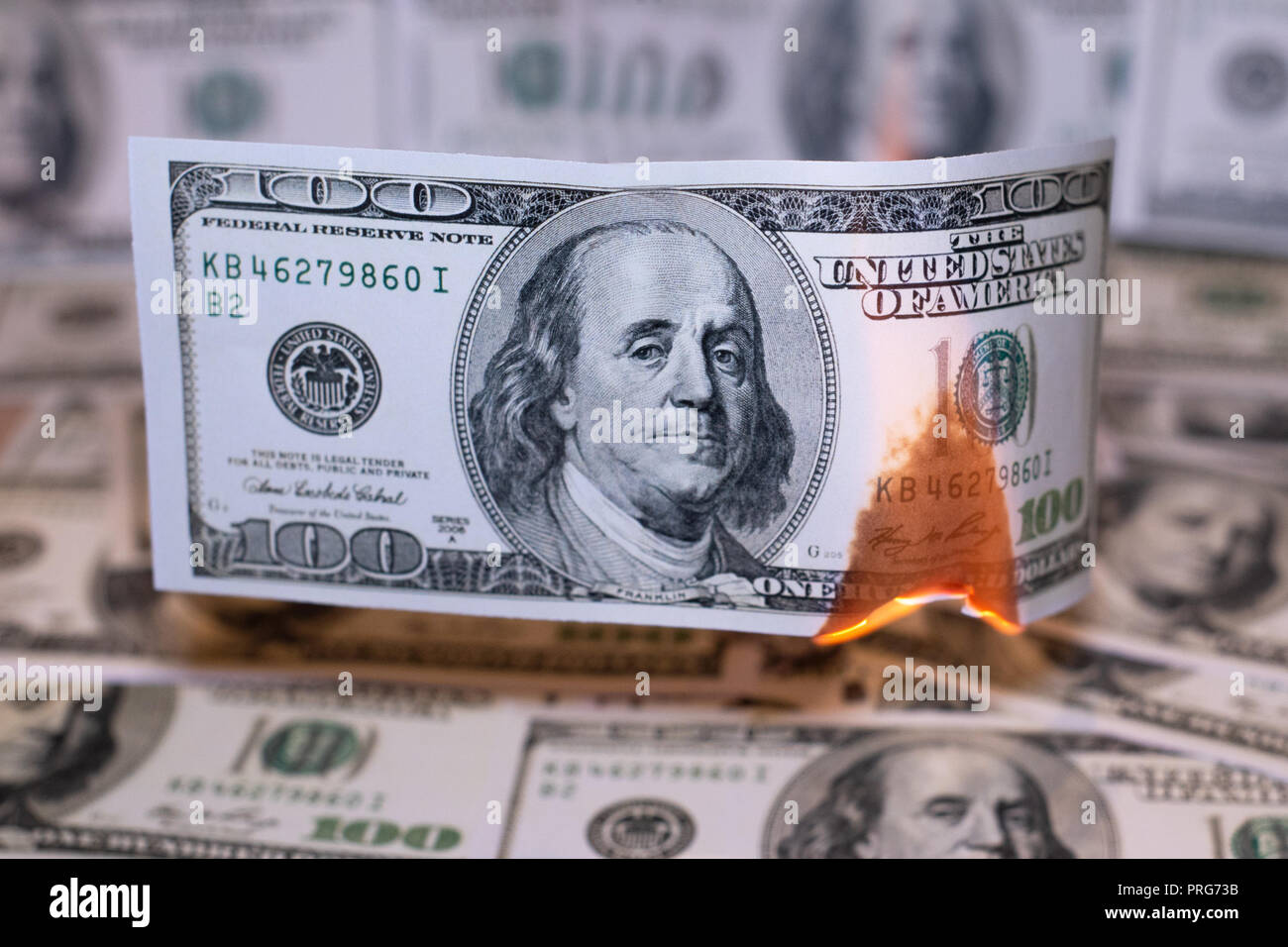 A hunred dollar bill in American US currency is on fire Stock Photo - Alamy