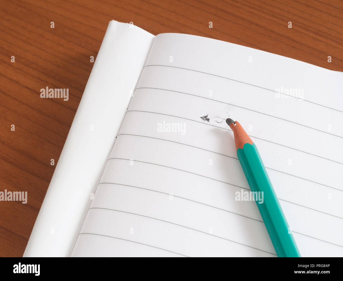 Broken pencil lead on blank lined paper. Stress or writers block Stock ...