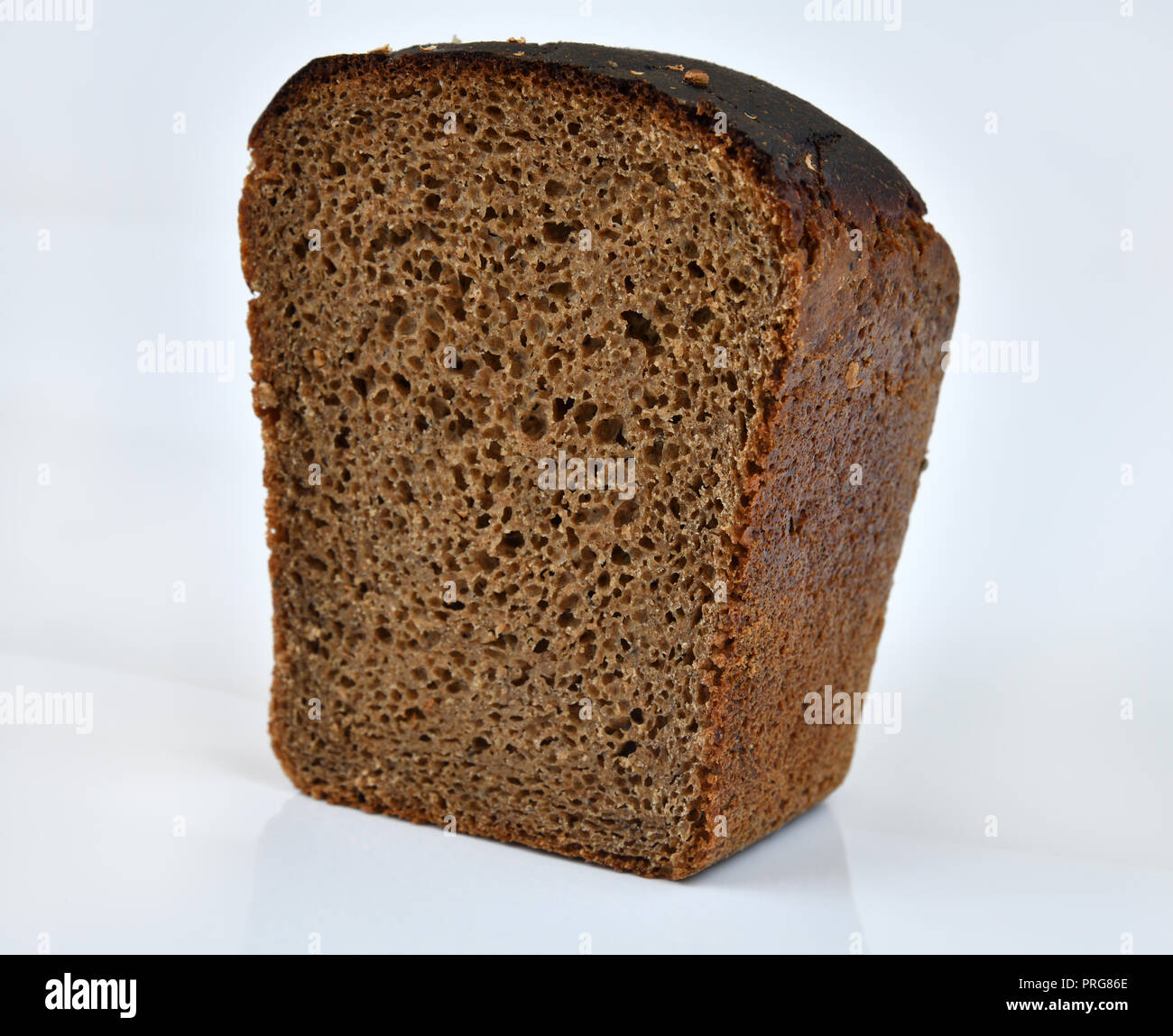 a large piece of black rye bread on a light background Stock Photo - Alamy