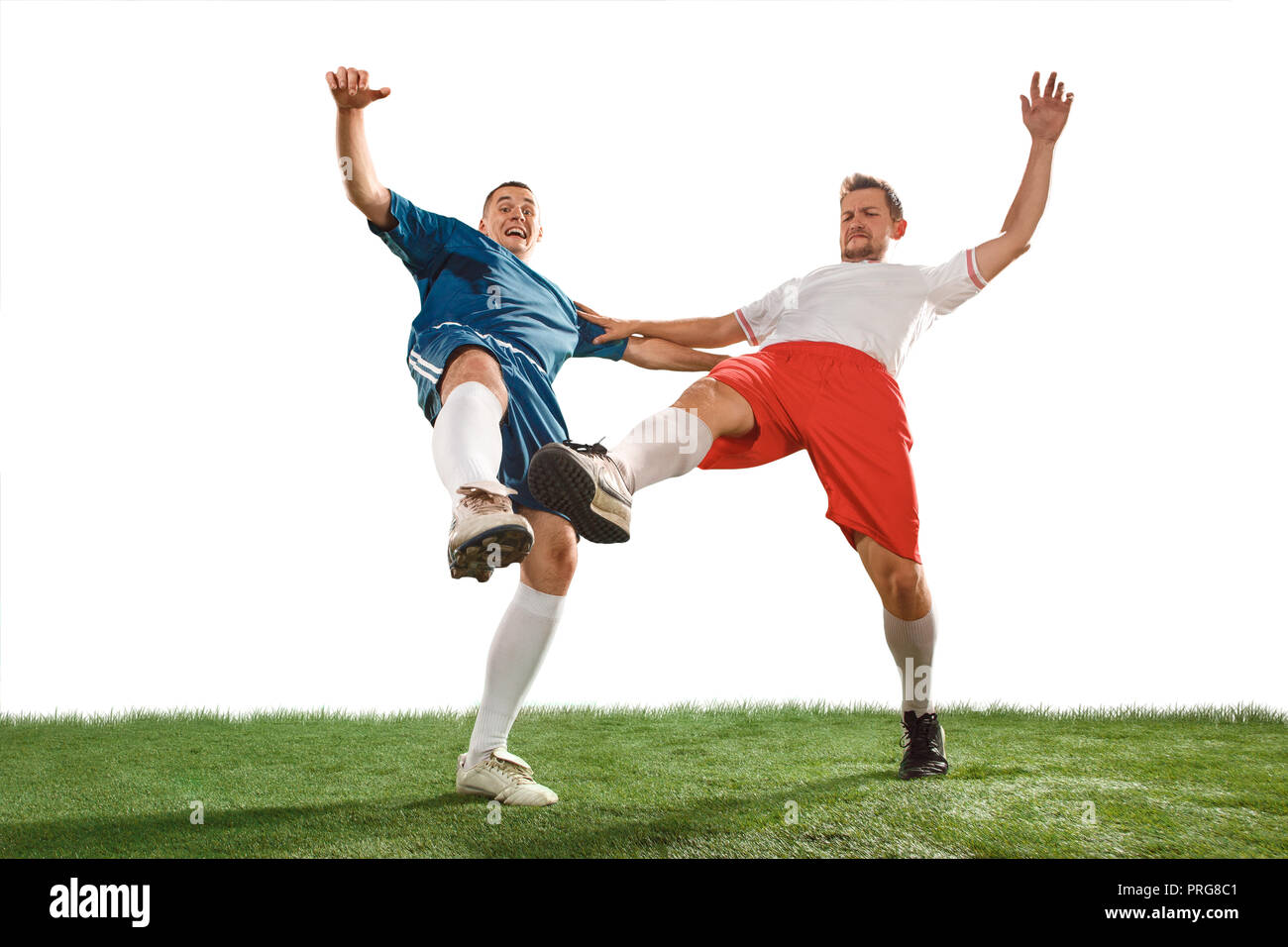 Football players tackling for the ball over white background ...