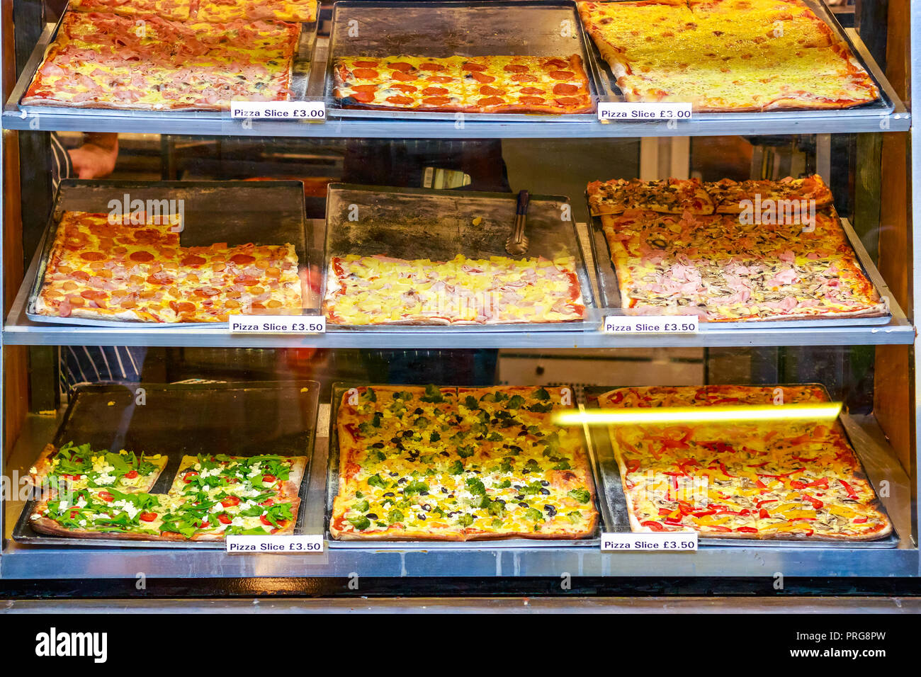 Variety of pizza slices on display for takeaway at Camden Market in ...