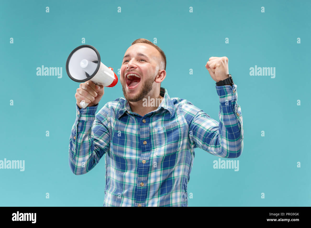 man making announcement with megaphone at blue studio background Stock ...