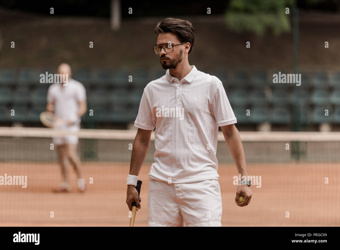 retro styled tennis player walking with racket at court Stock Photo - Alamy