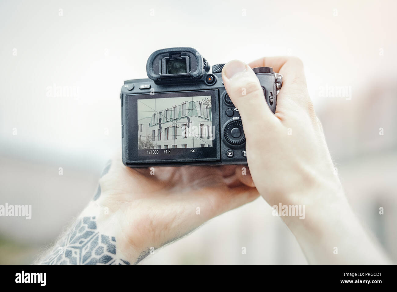 Close up of man hands holding camera and making photos of modern ...