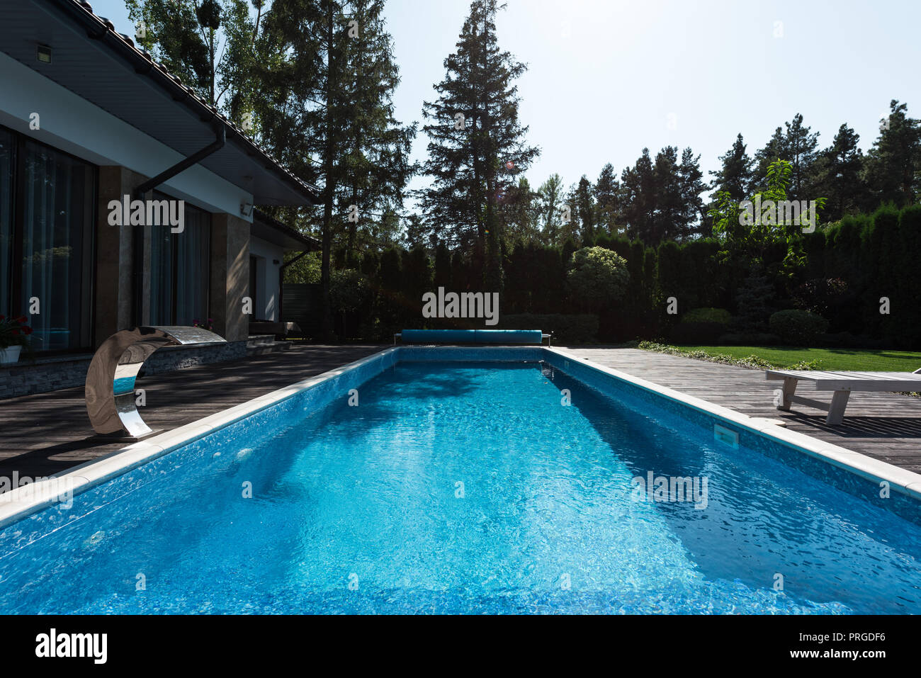 view of modern house with blue swimming pool Stock Photo - Alamy