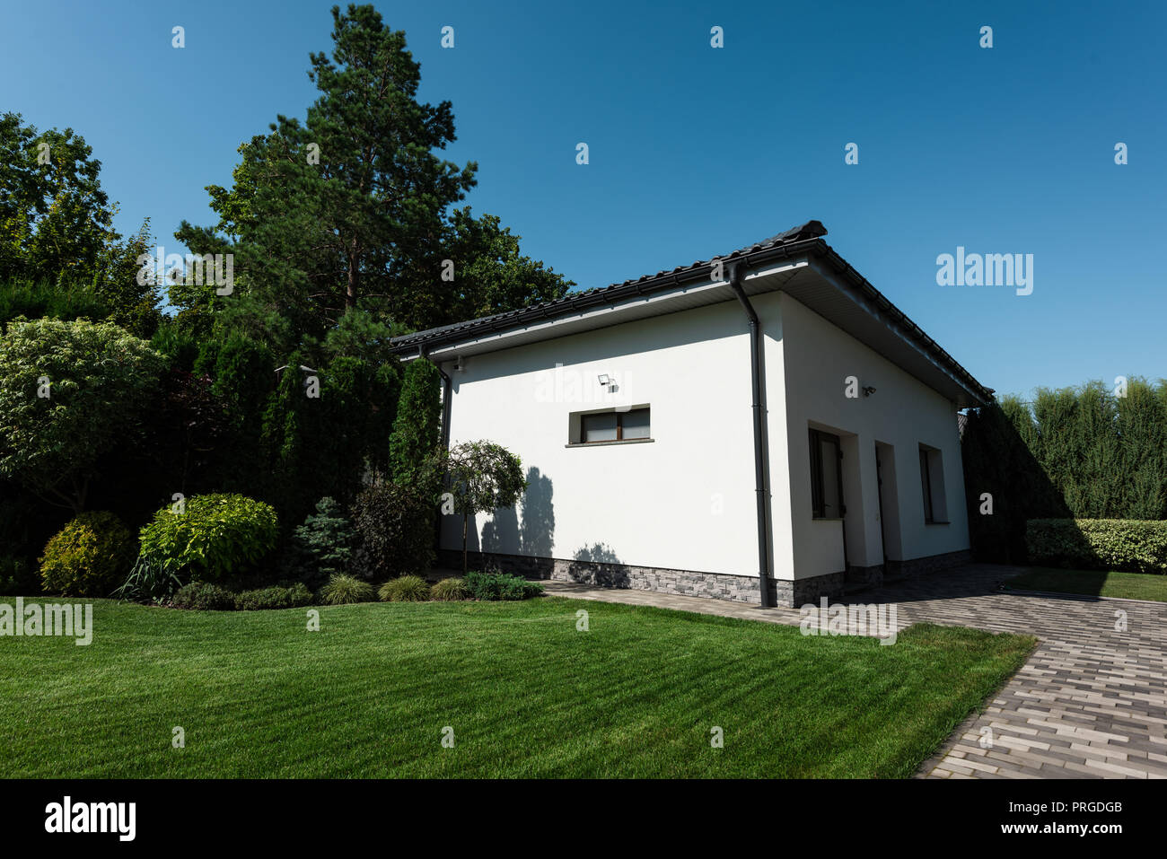 outside view of house with green garden Stock Photo - Alamy
