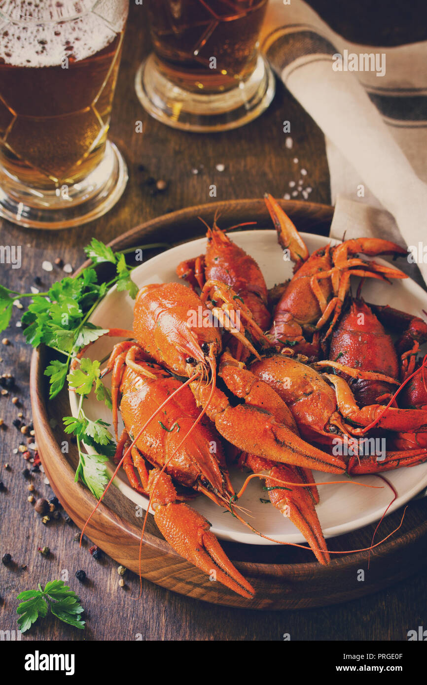 Boiled Crawfish and Fresh Beer in Beakers on a wooden table. Appetizer ...
