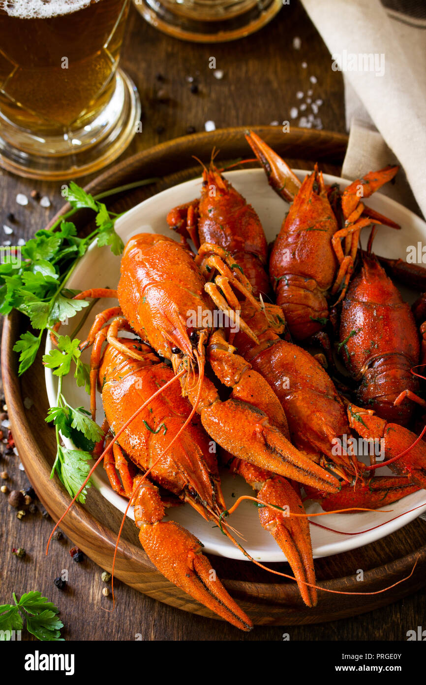 Boiled Crawfish and Fresh Beer in Beakers on a wooden table. Appetizer ...
