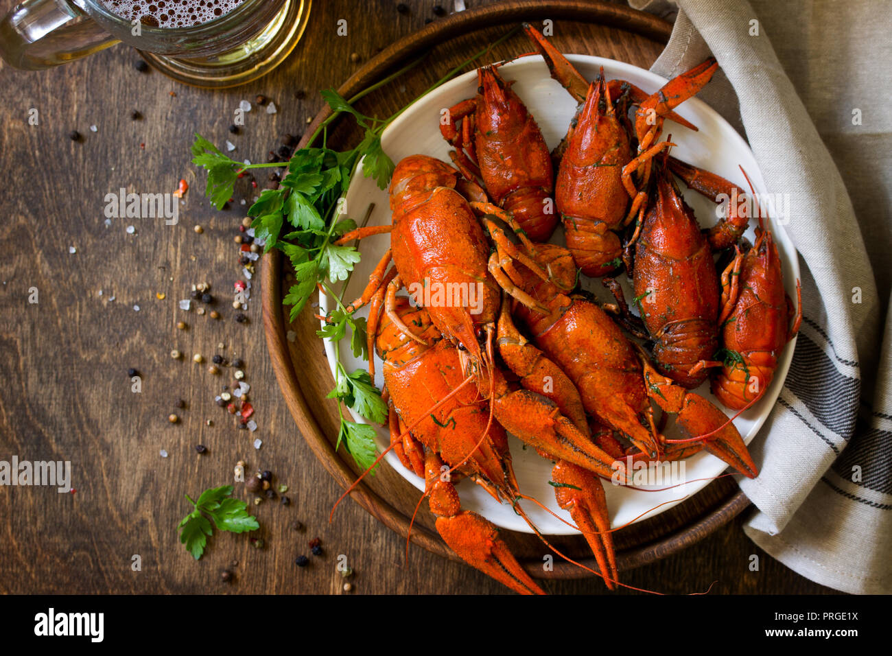Boiled Crawfish and Fresh Beer in Beakers on a wooden table. Appetizer ...
