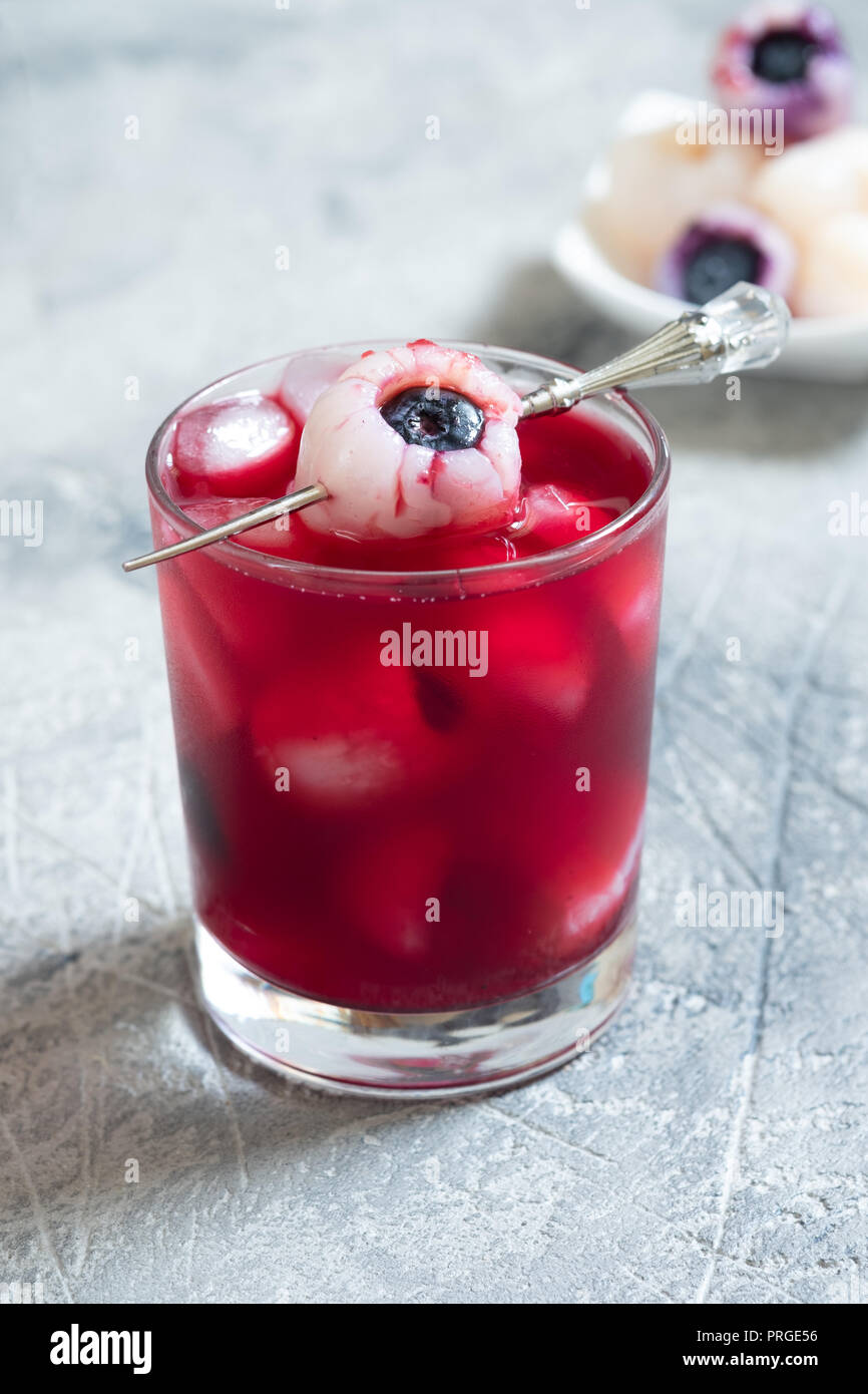 Red halloween cocktail with eye Stock Photo - Alamy