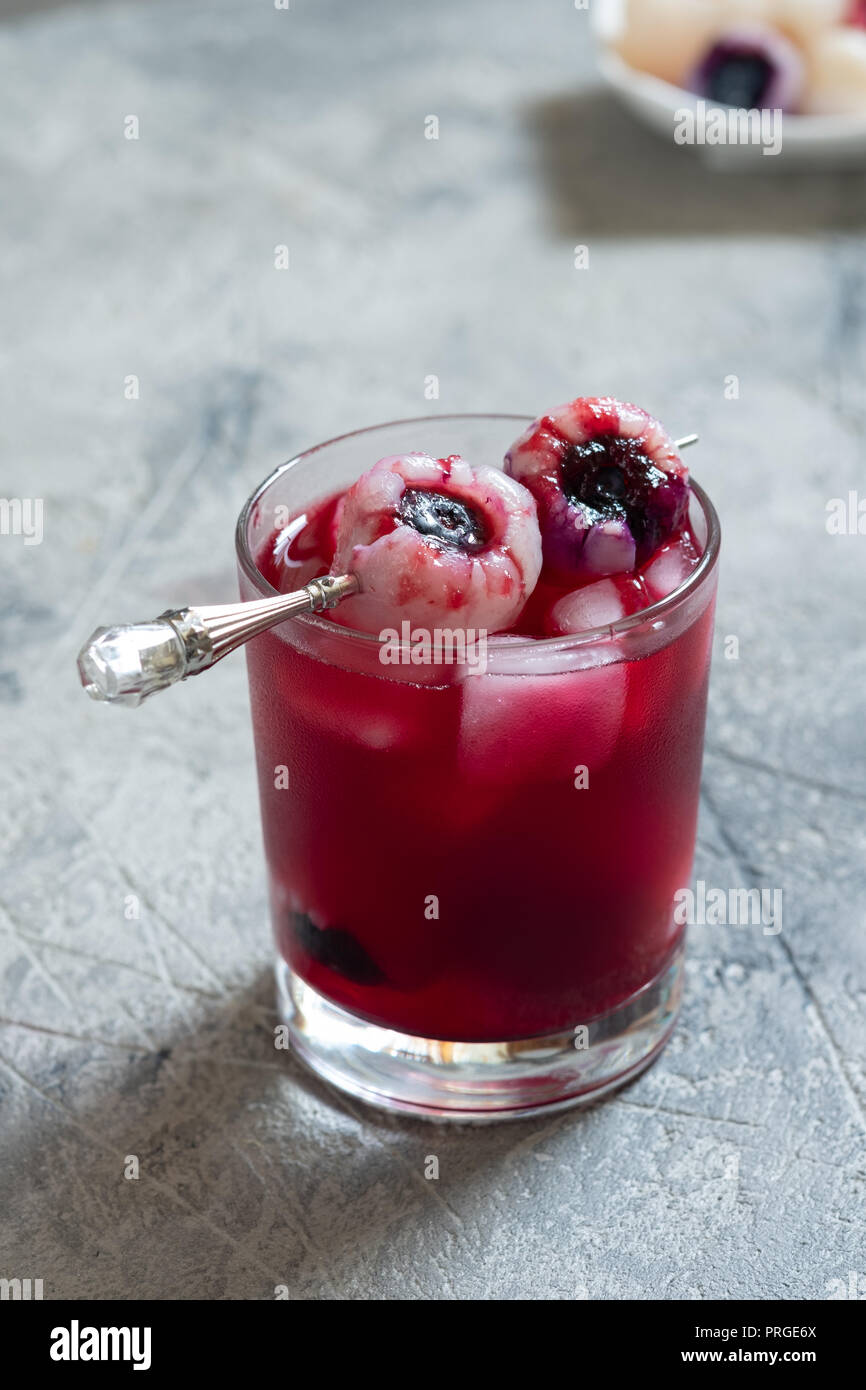Red halloween cocktail with eye Stock Photo - Alamy