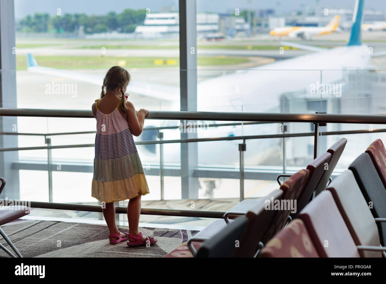 Kids at airport. Children look at airplane. Traveling and flying with ...