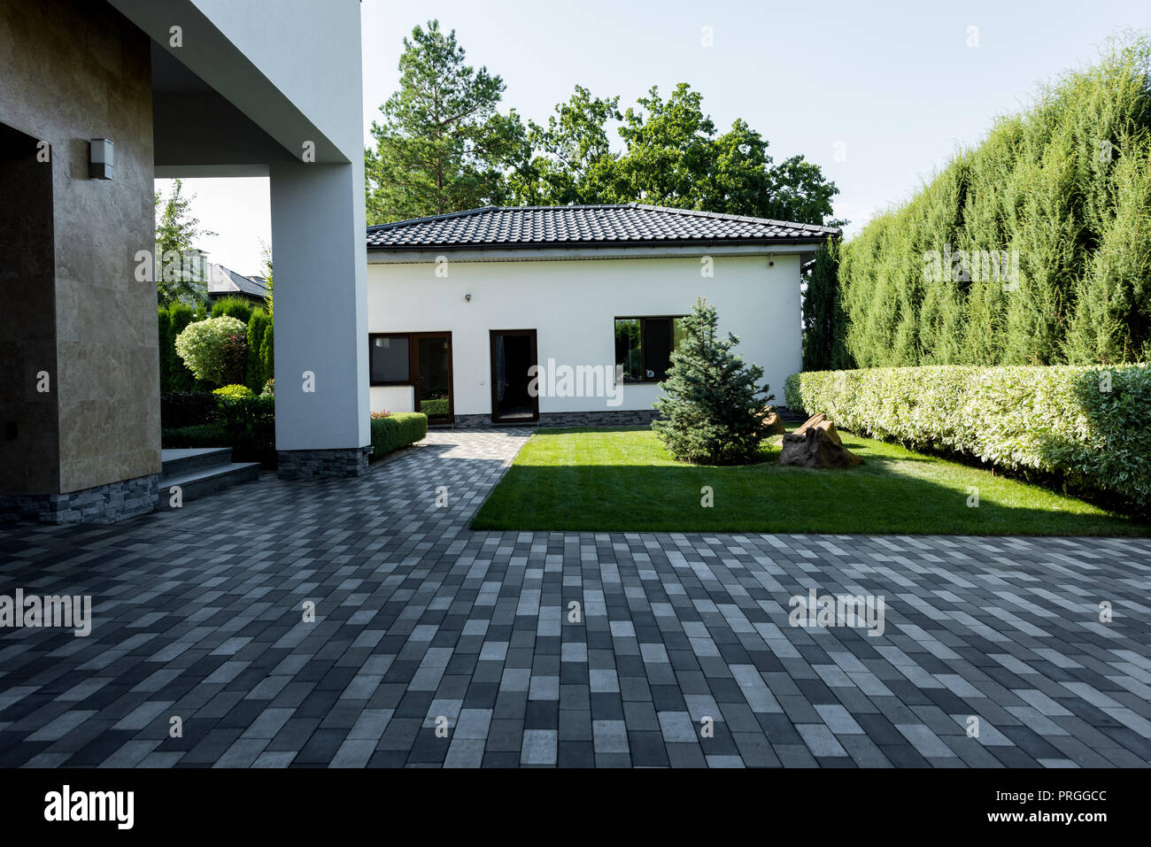 facade of new modern house with empty parking and green lawn Stock ...