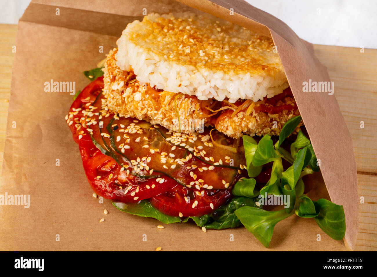 Rice burger with crispy chicken Stock Photo - Alamy
