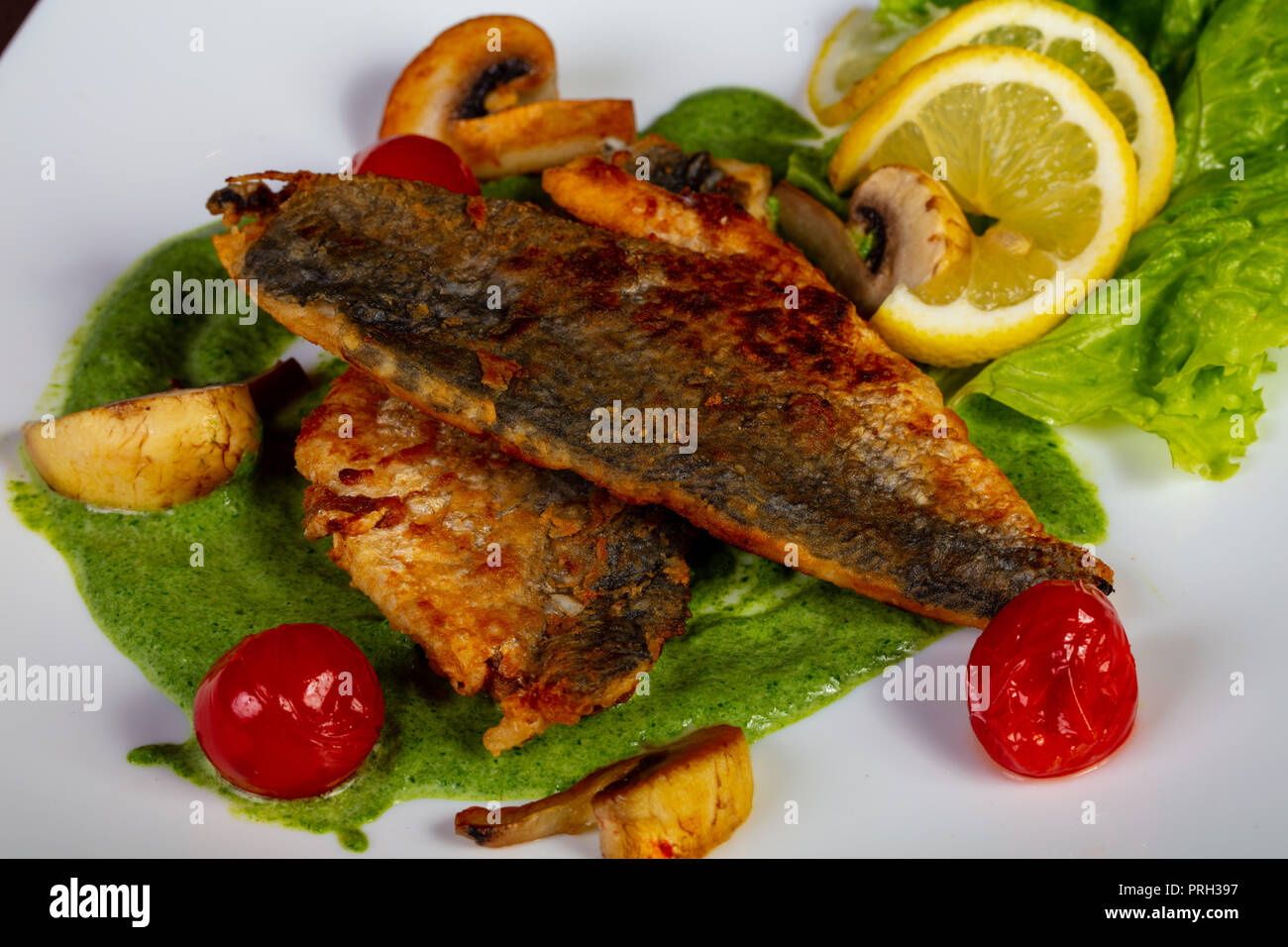 Roasted Dorado fish fillet with sauce Stock Photo - Alamy